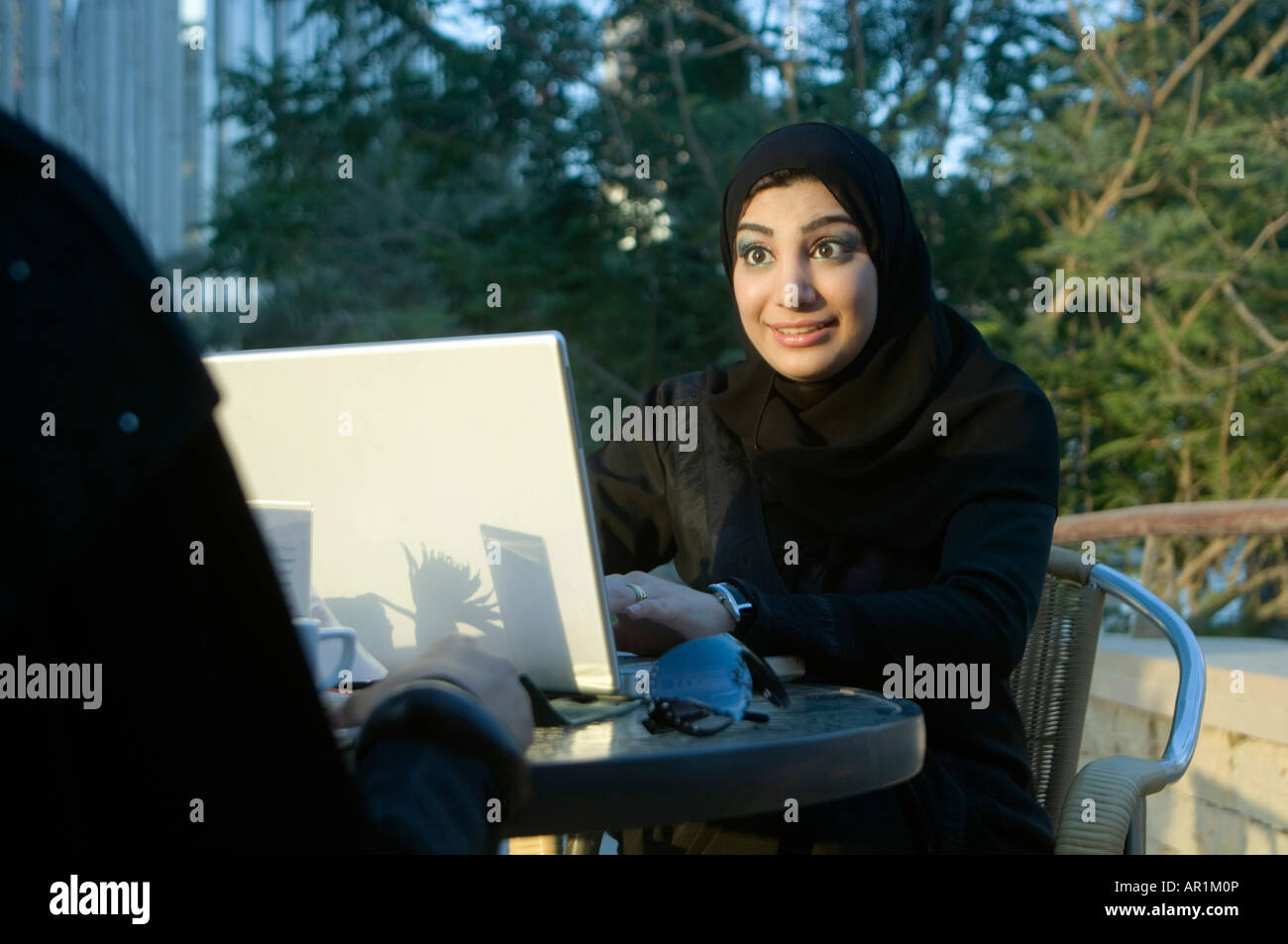 Arab Lady outdoors working on a computer Stock Photo - Alamy