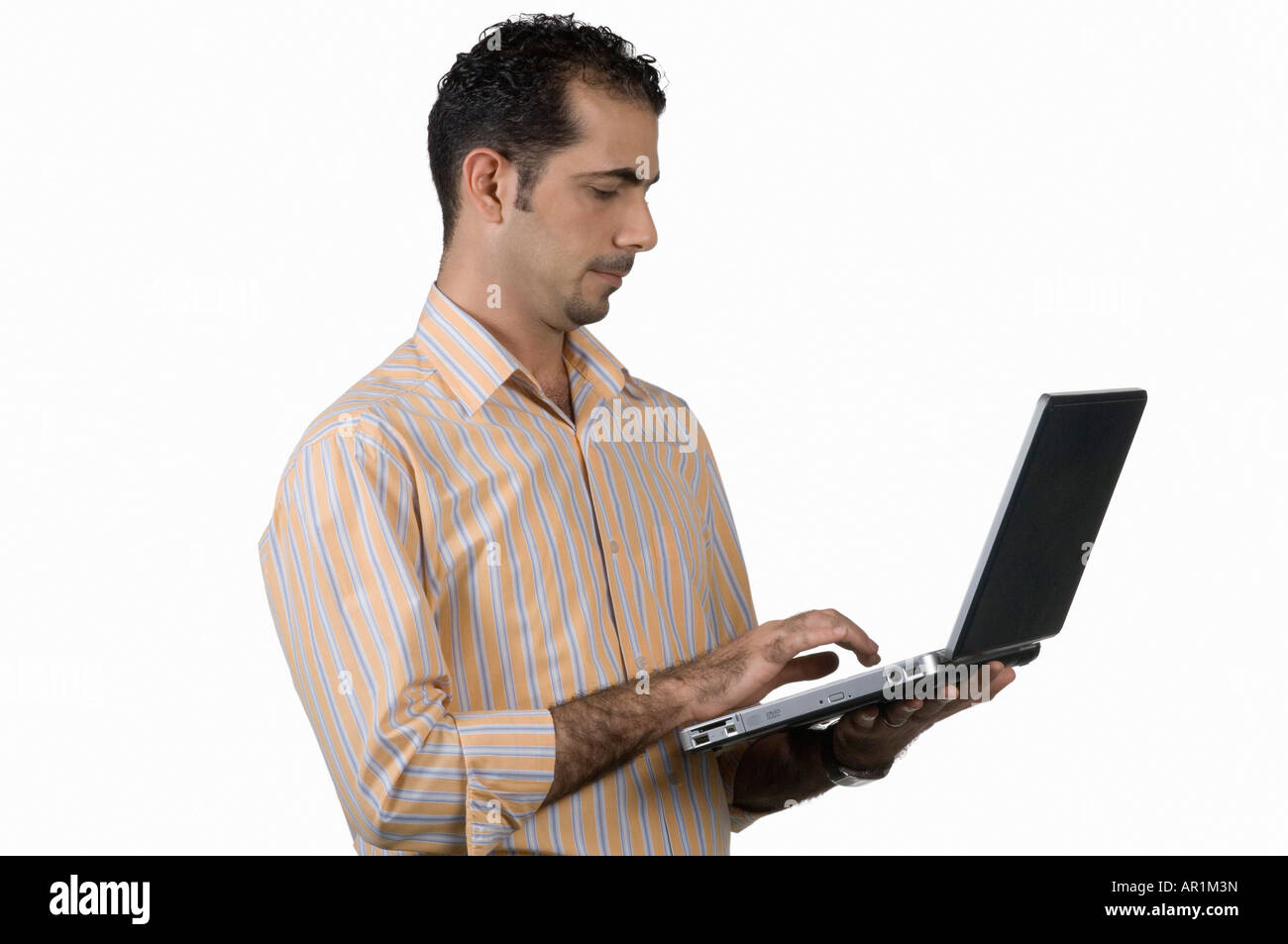 Man holding a laptop computer Stock Photo - Alamy