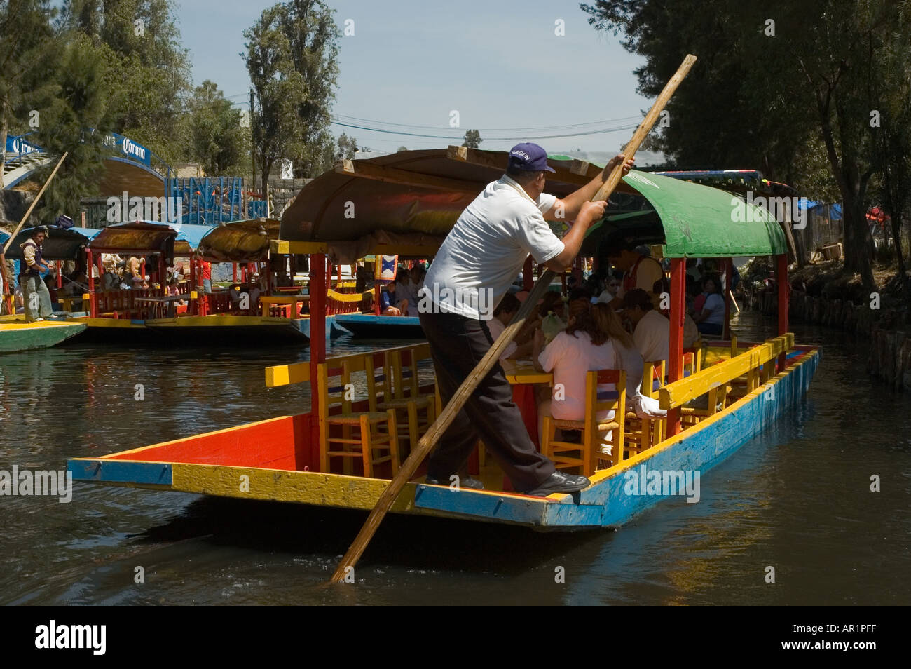 MEXICO Xochimilco propelling traditional Mexican barges on the canal ...