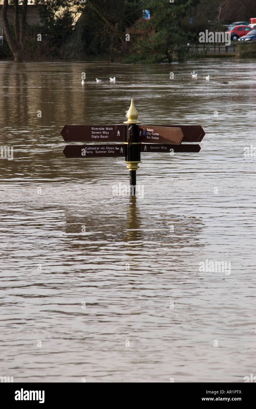 A direction sign surrounded by flood water from the River Severn in ...