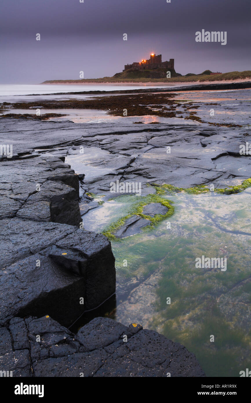 Volcanic basalt rocks at Bamburgh Castle, Northumberland Stock Photo ...