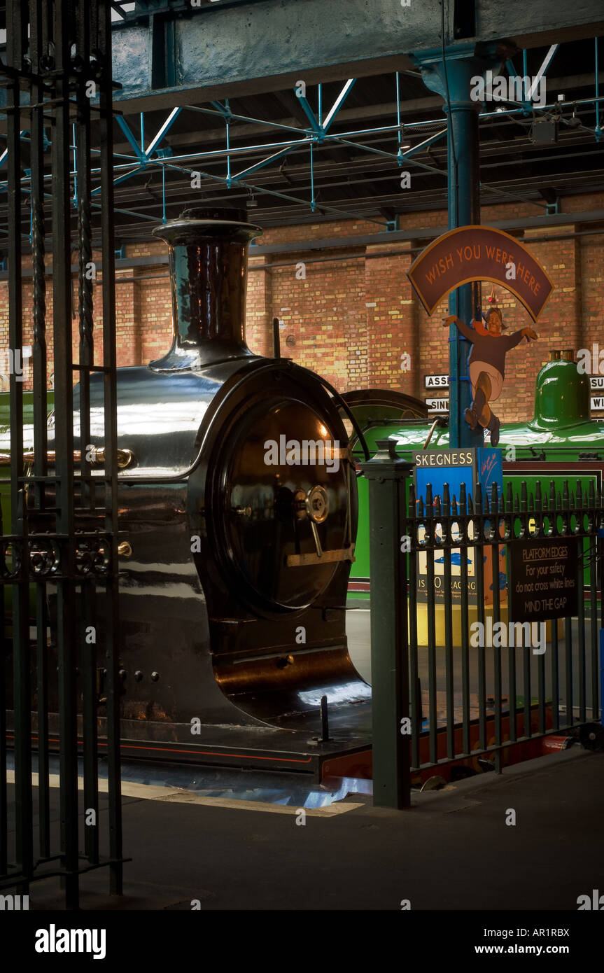 Steam train glimpsed through the platform gates of the Station Hall at ...