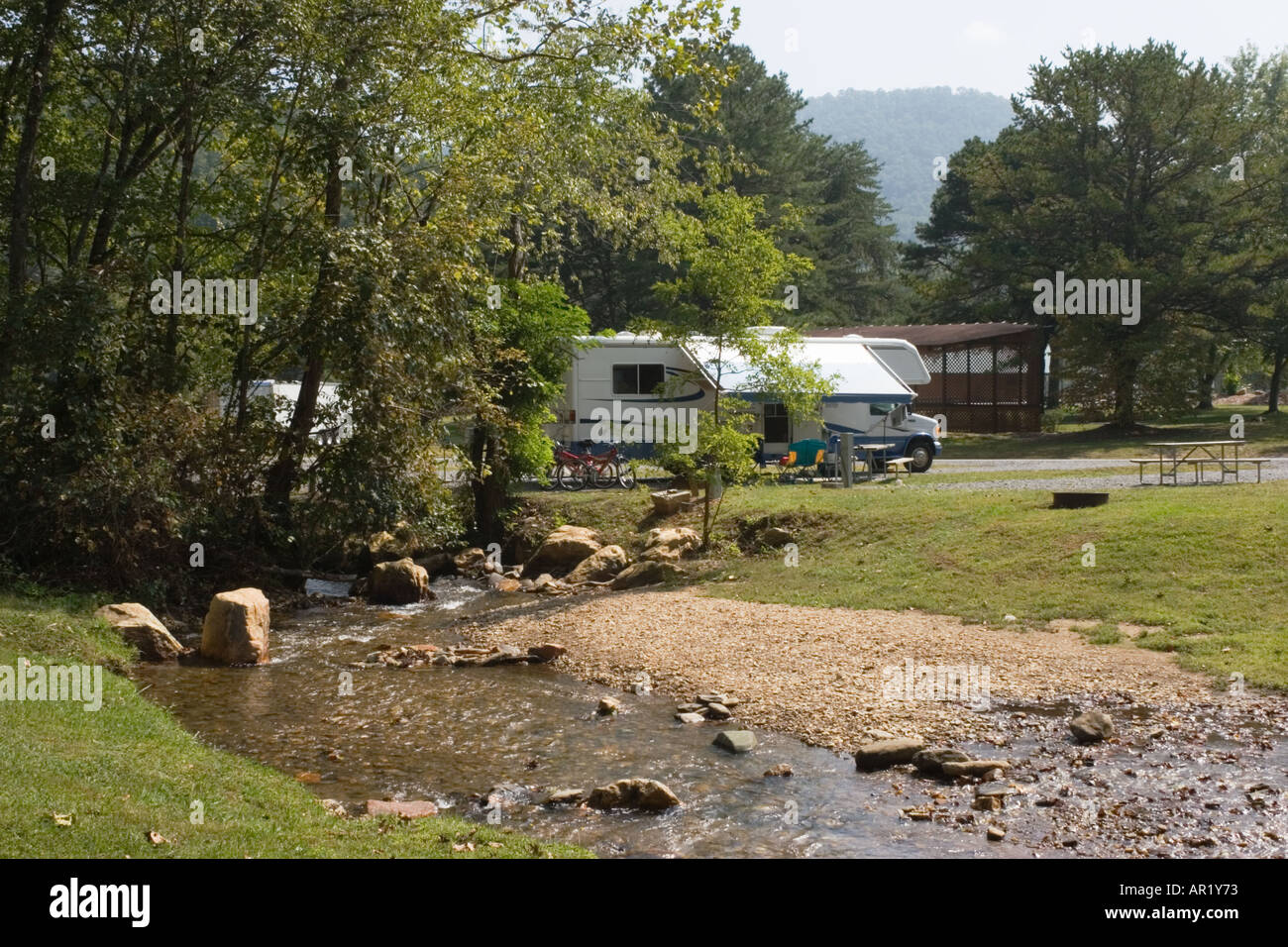 Motorhome camper parked beside creek in private mountain campground in ...