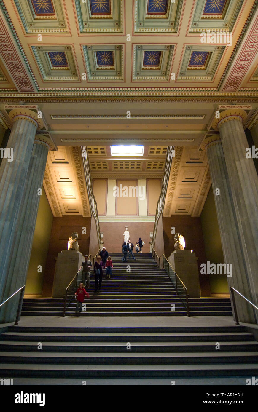 Vertical wide angle of a family descending the grand stone staircase ...