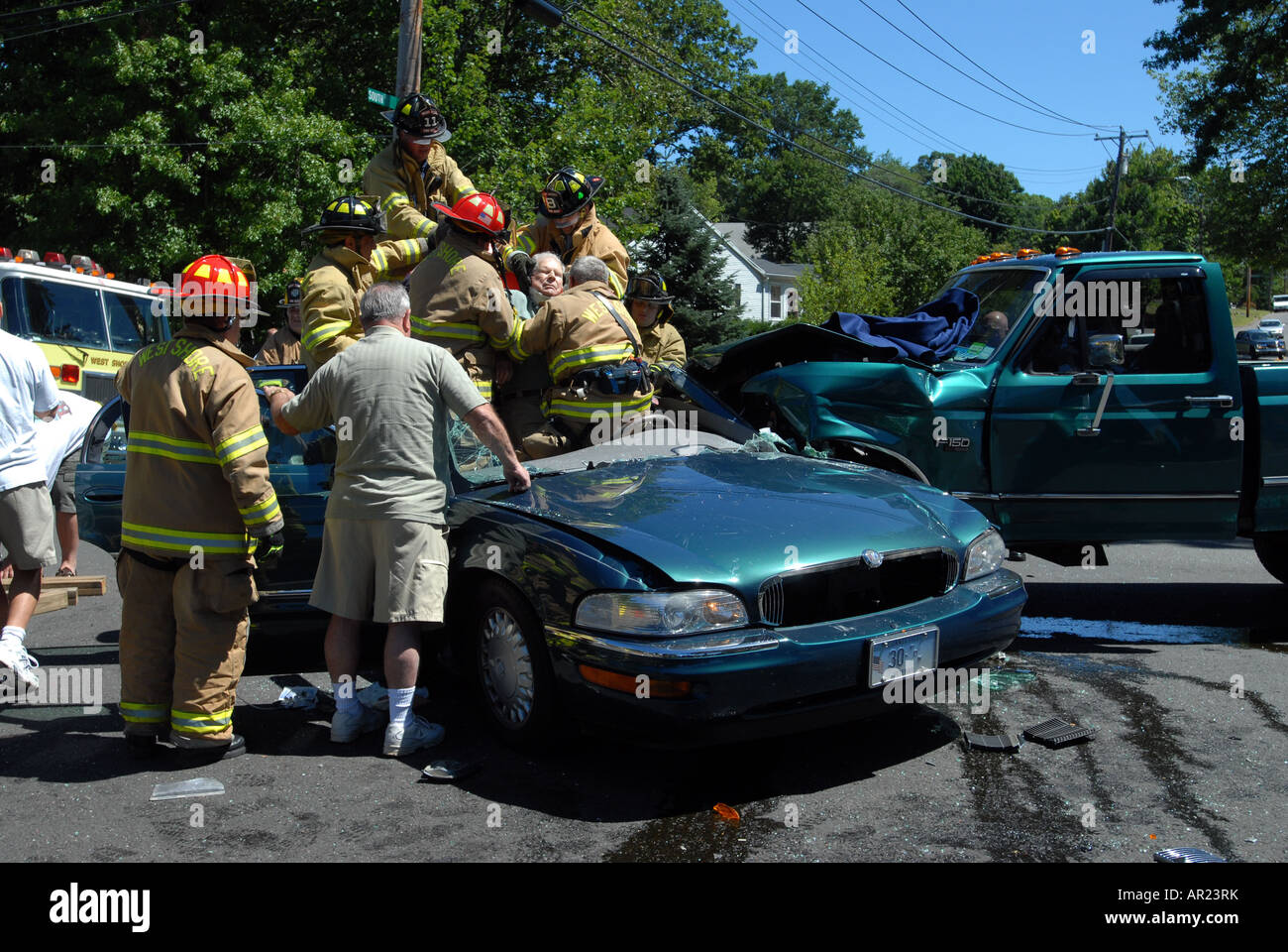 A man being extricated from a two-car crash by firefighters using the ...