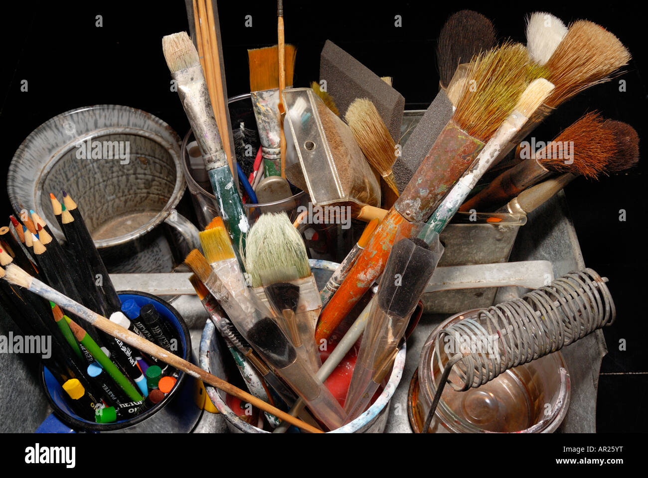 Artist paint asorted paint brushes and colored pencils Stock Photo - Alamy