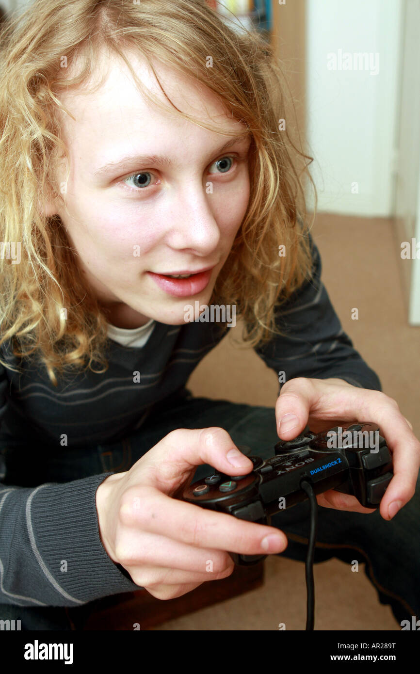 A boy plays on a games console Stock Photo - Alamy