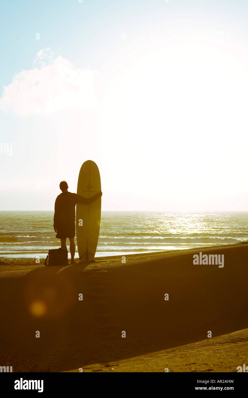 Surfer walking on the beach in Baja Mexico Stock Photo - Alamy