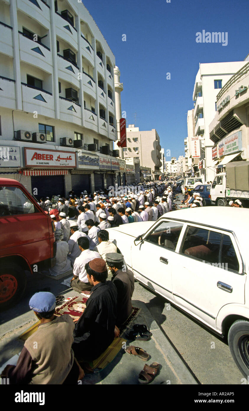 UAE Dubai religion muslim worshippers praying in street outside Mosque ...