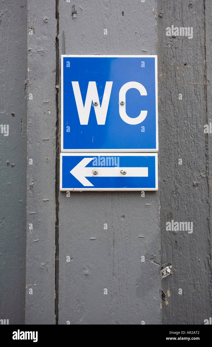 wc sign with arrow pointing left Stock Photo - Alamy
