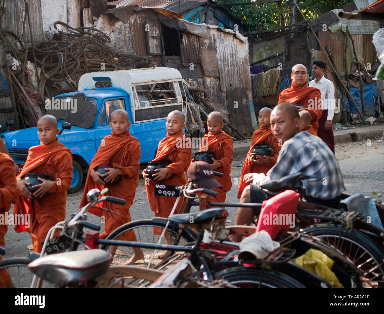 group of boy monks making alms rounds in Yangon in Burma Stock Photo ...