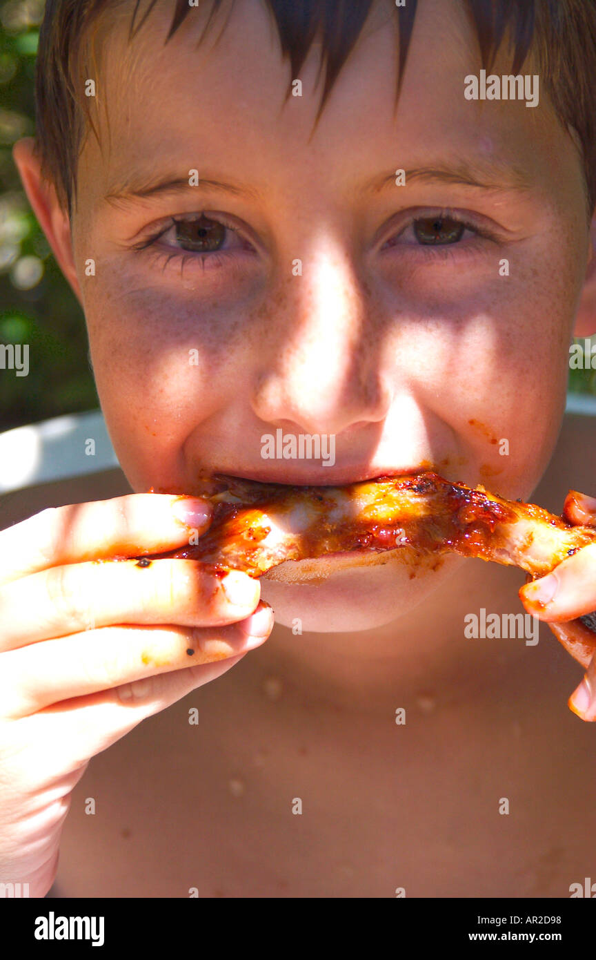 boy eating ribs Stock Photo - Alamy