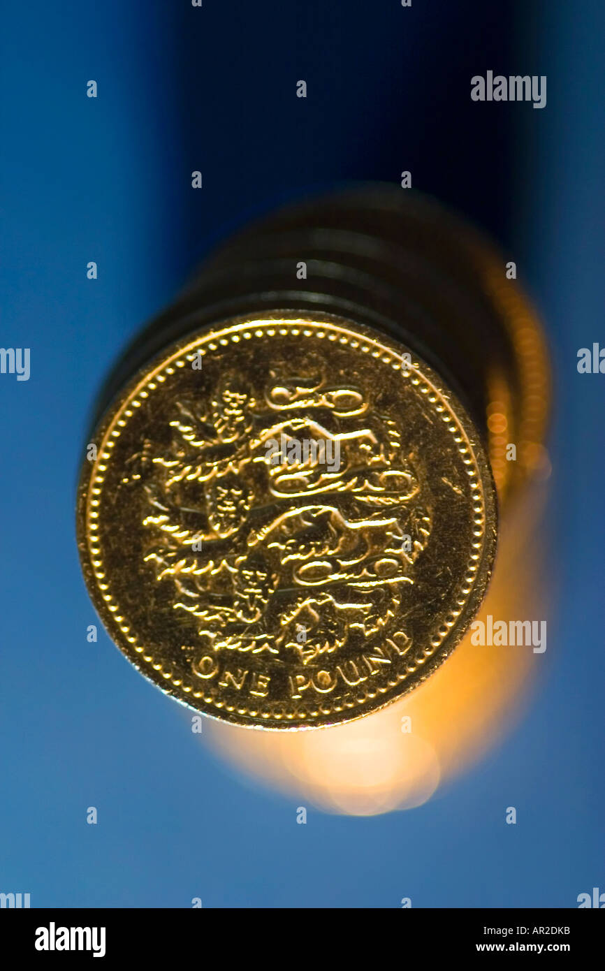 Stack of British pound coins on blue background Stock Photo - Alamy