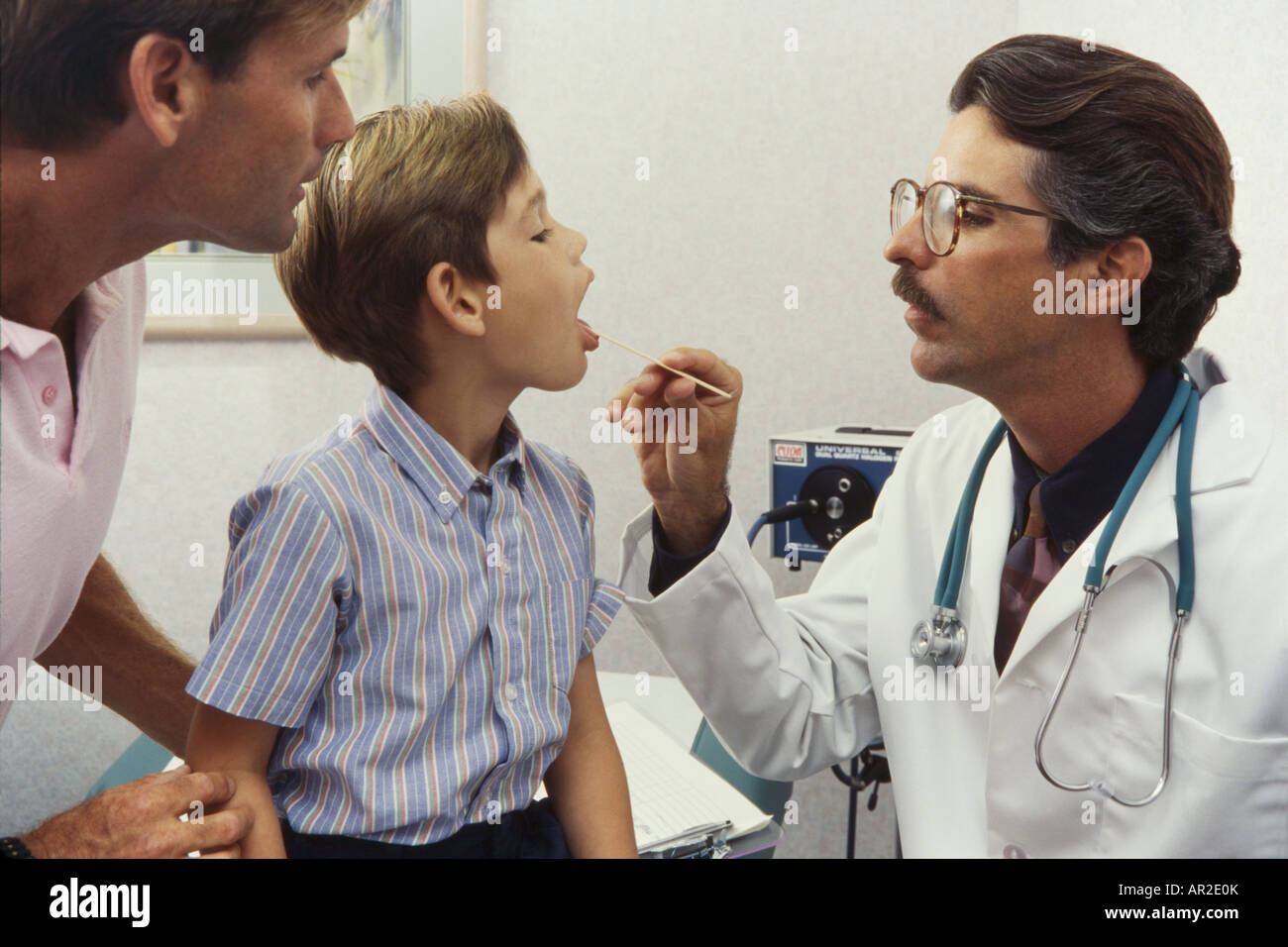 Doctor and young playful patient, physical exam, Miami Stock Photo - Alamy