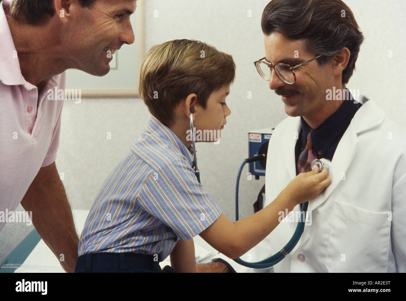 Doctor and young playful patient, physical exam, Miami Stock Photo - Alamy