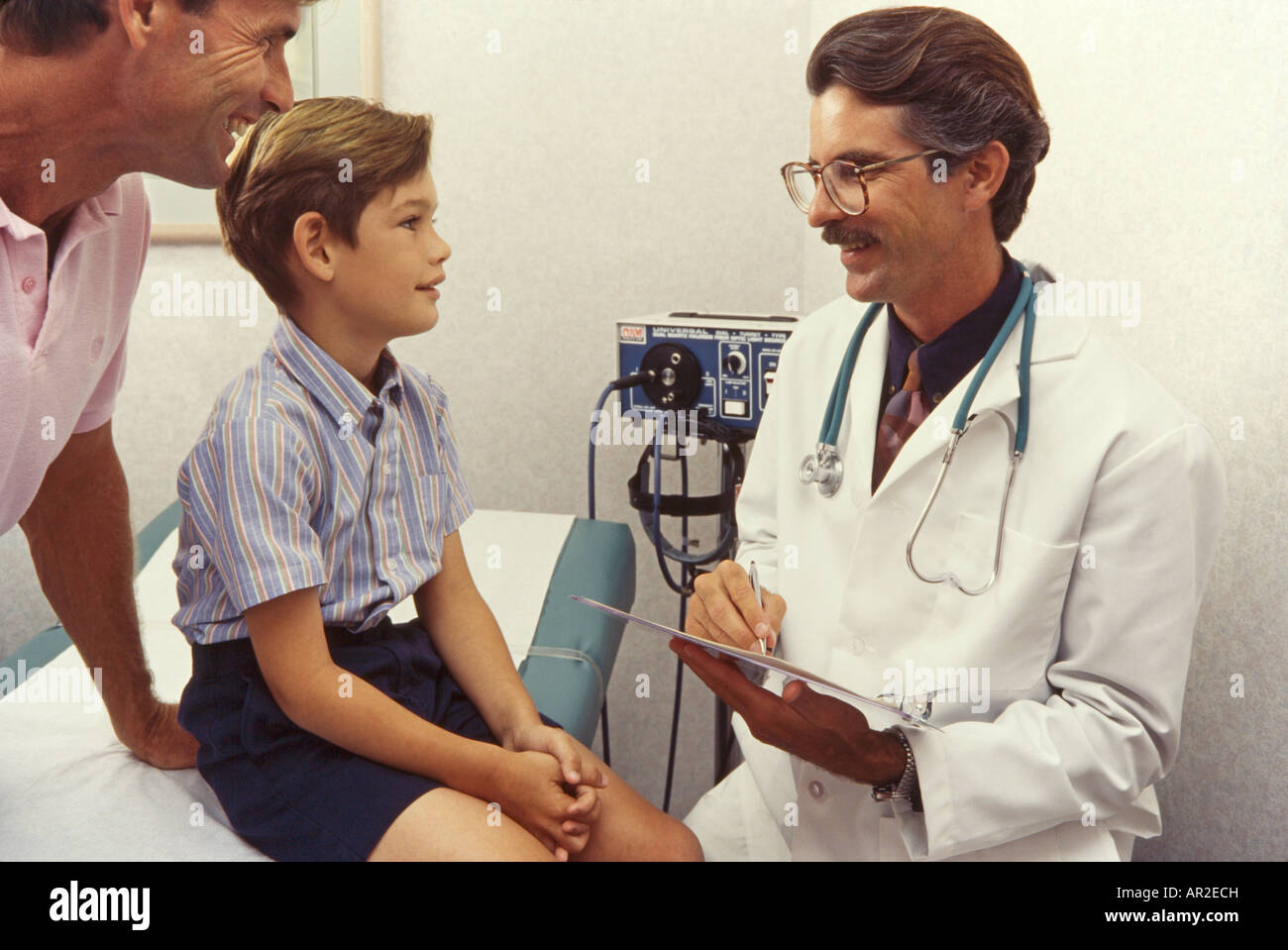 Doctor and young playful patient, physical exam, Miami Stock Photo - Alamy