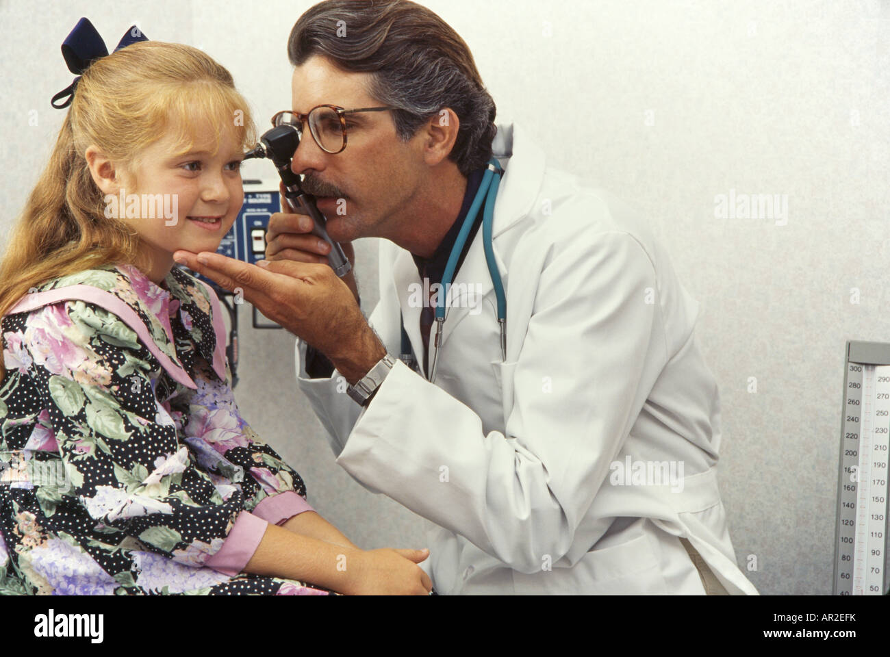 Doctor and young playful patient, physical exam, Miami Stock Photo - Alamy