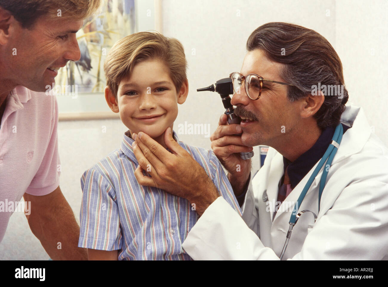 Doctor and young playful patient, physical exam, Miami Stock Photo - Alamy