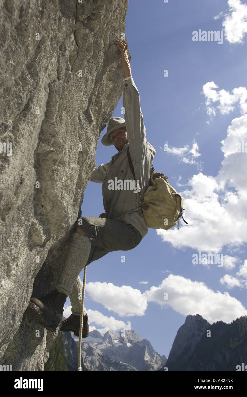historic mountain climber climbing at a rock wall, Austria, Gosautal ...