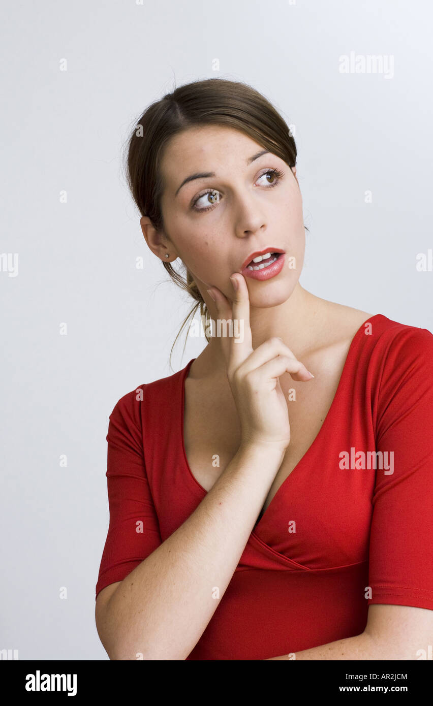 young woman with one hand at chin Stock Photo - Alamy