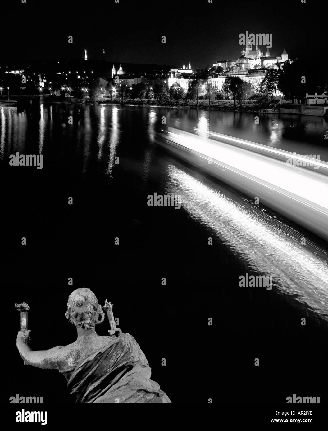 Statue at the Cechuv most and Prague Castle at night Stock Photo - Alamy