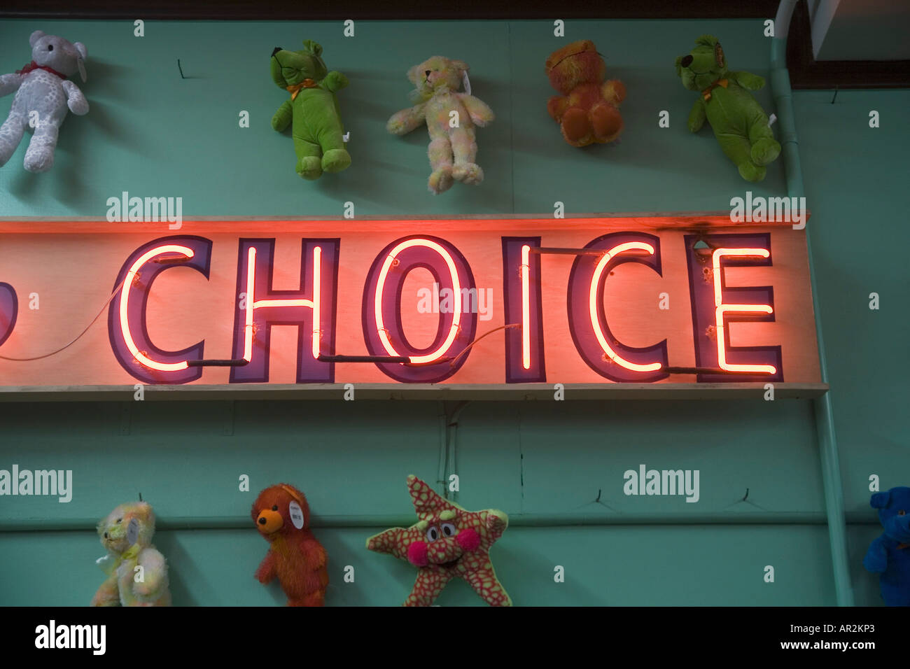 Teddy bears surrounding choice neon sign Stock Photo - Alamy
