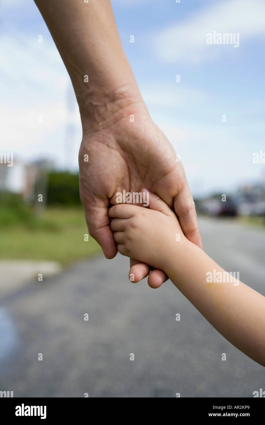Father holding child s hand Stock Photo - Alamy