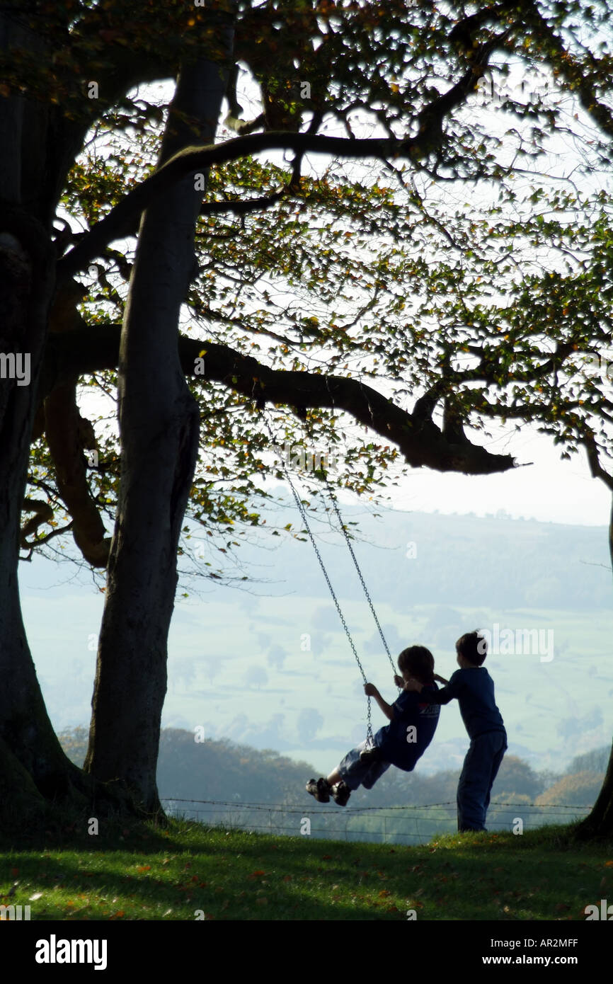 Kids on swing pushing hi-res stock photography and images - Alamy