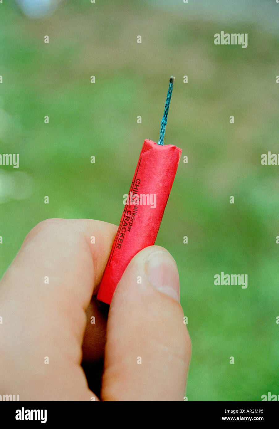 Man holding single firework Stock Photo - Alamy