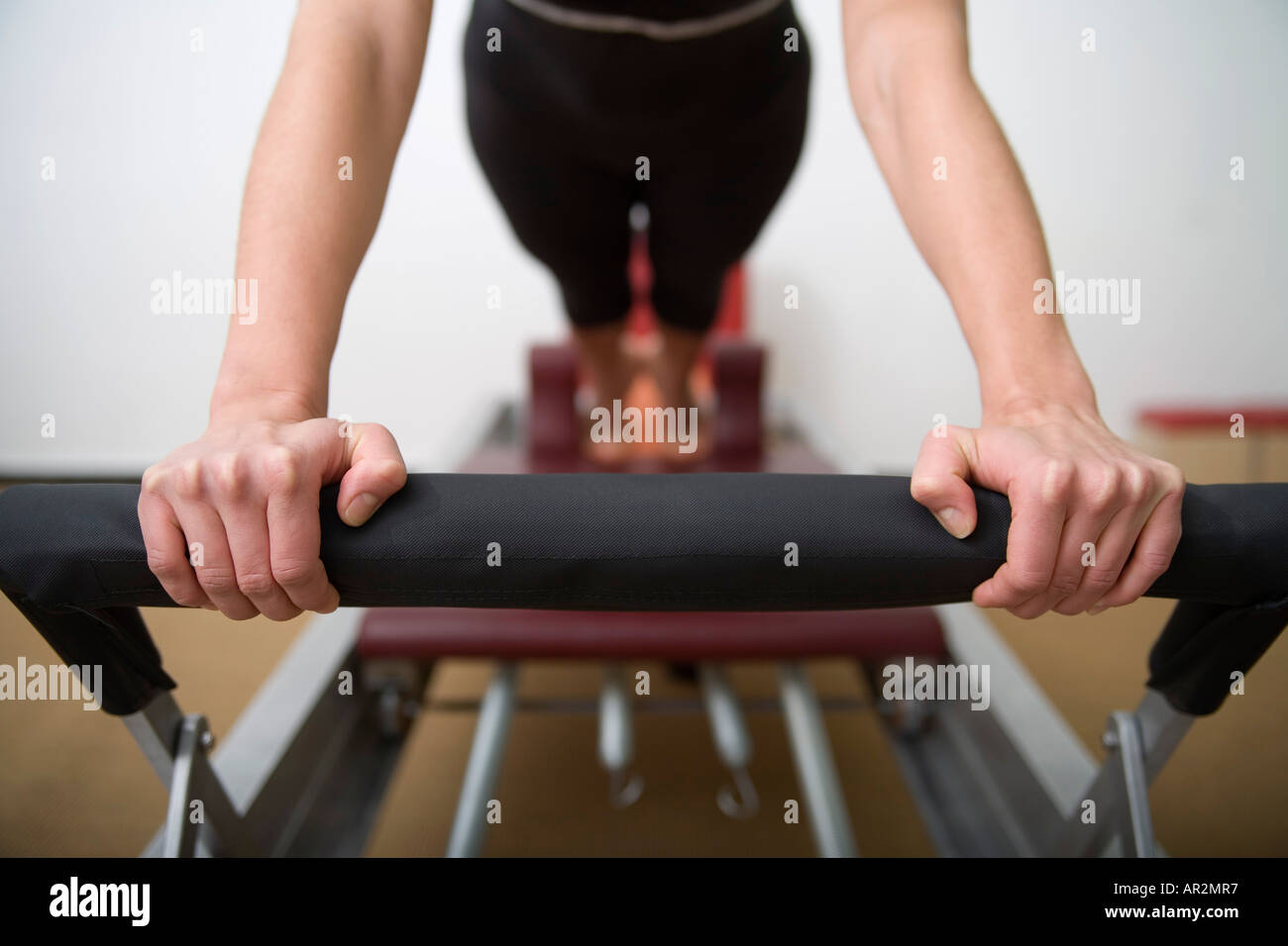 Woman exercising on Pilates bench Stock Photo - Alamy