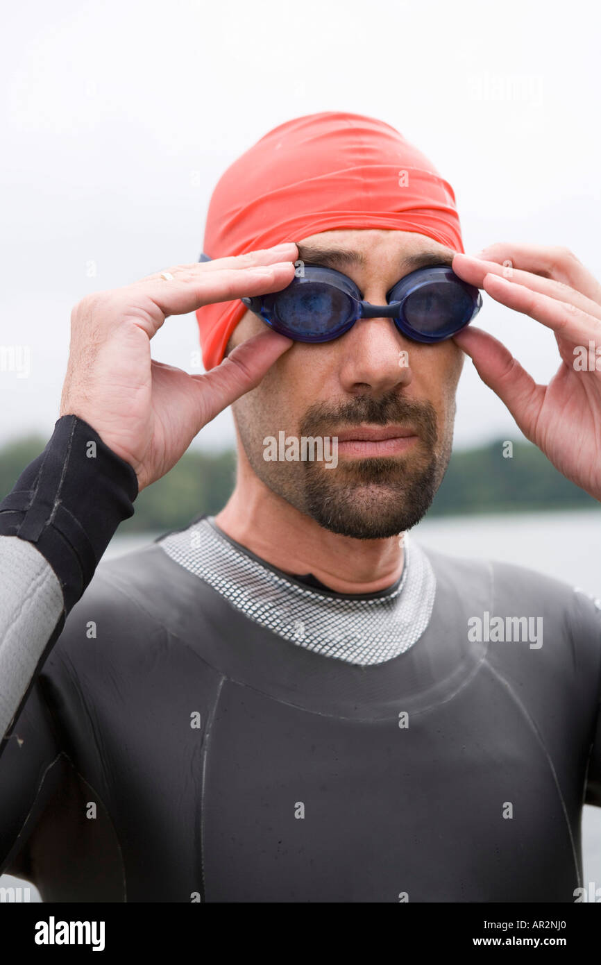 Man adjusting swimming goggles hi-res stock photography and images - Alamy
