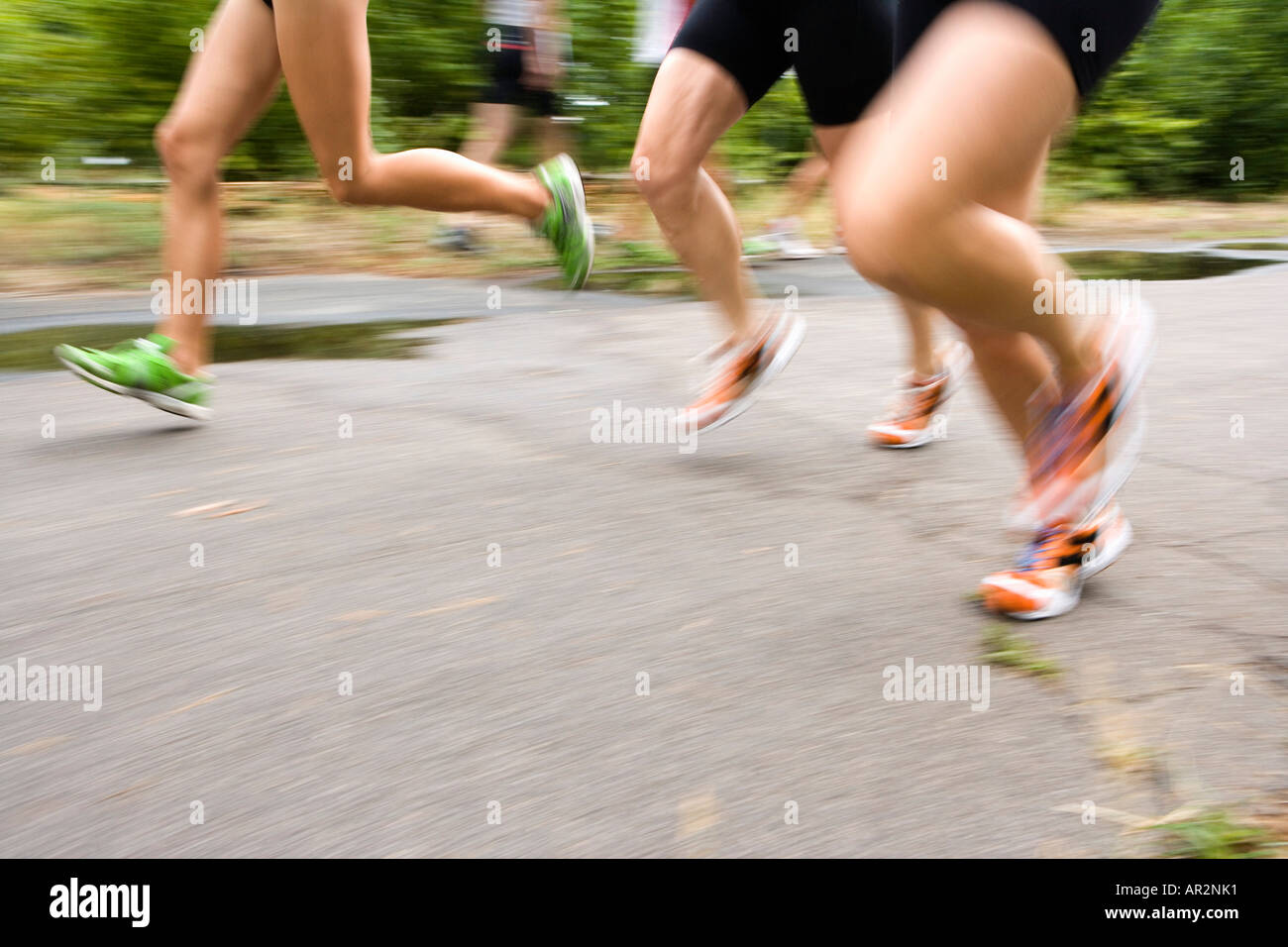 Three men running on road Stock Photo - Alamy