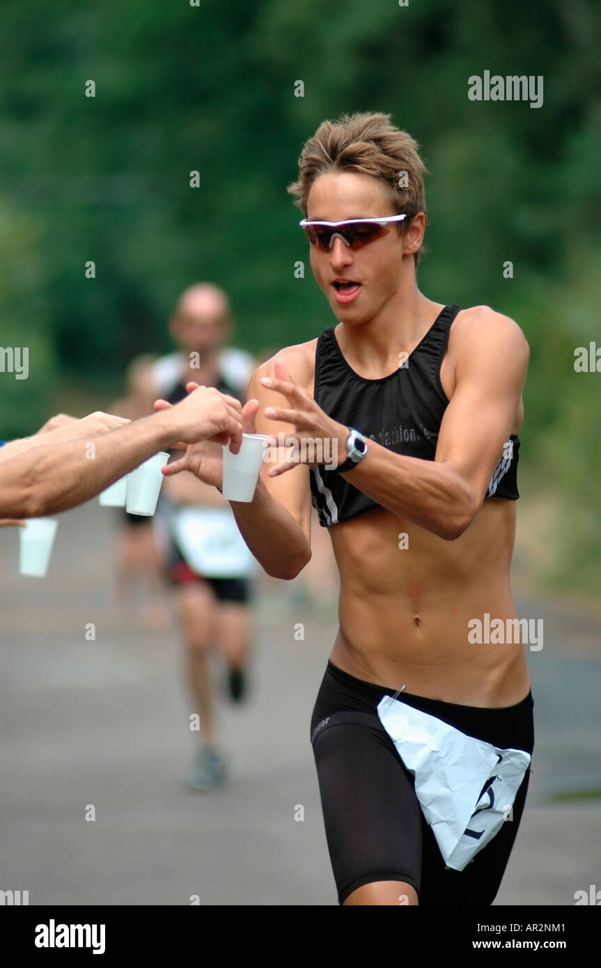 Running marathon reaching water hi-res stock photography and images - Alamy