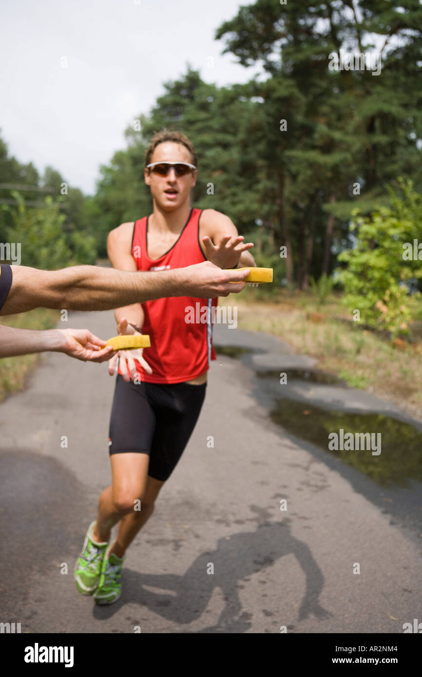 Running marathon reaching water hi-res stock photography and images - Alamy