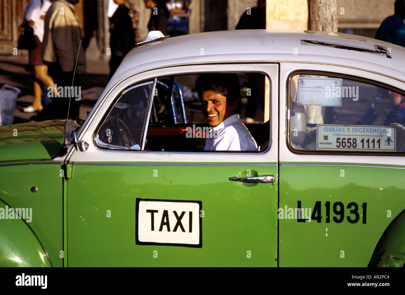 Taxi driver in typical green Beetle, Zocalo main square, Mexico City ...