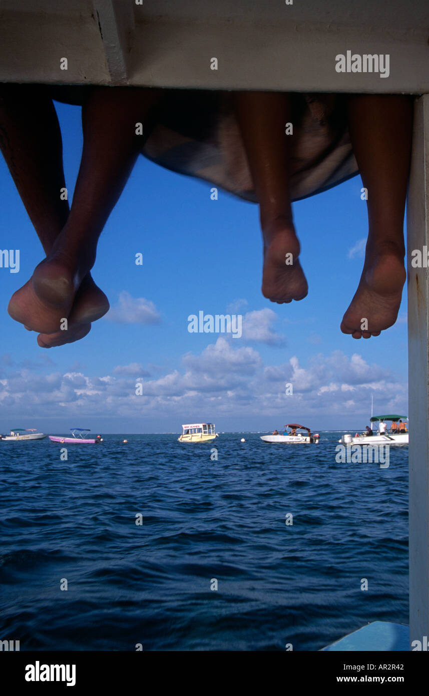 Dangling feet on dive boat at Shark Ray Alley and Hol Chan Marine ...