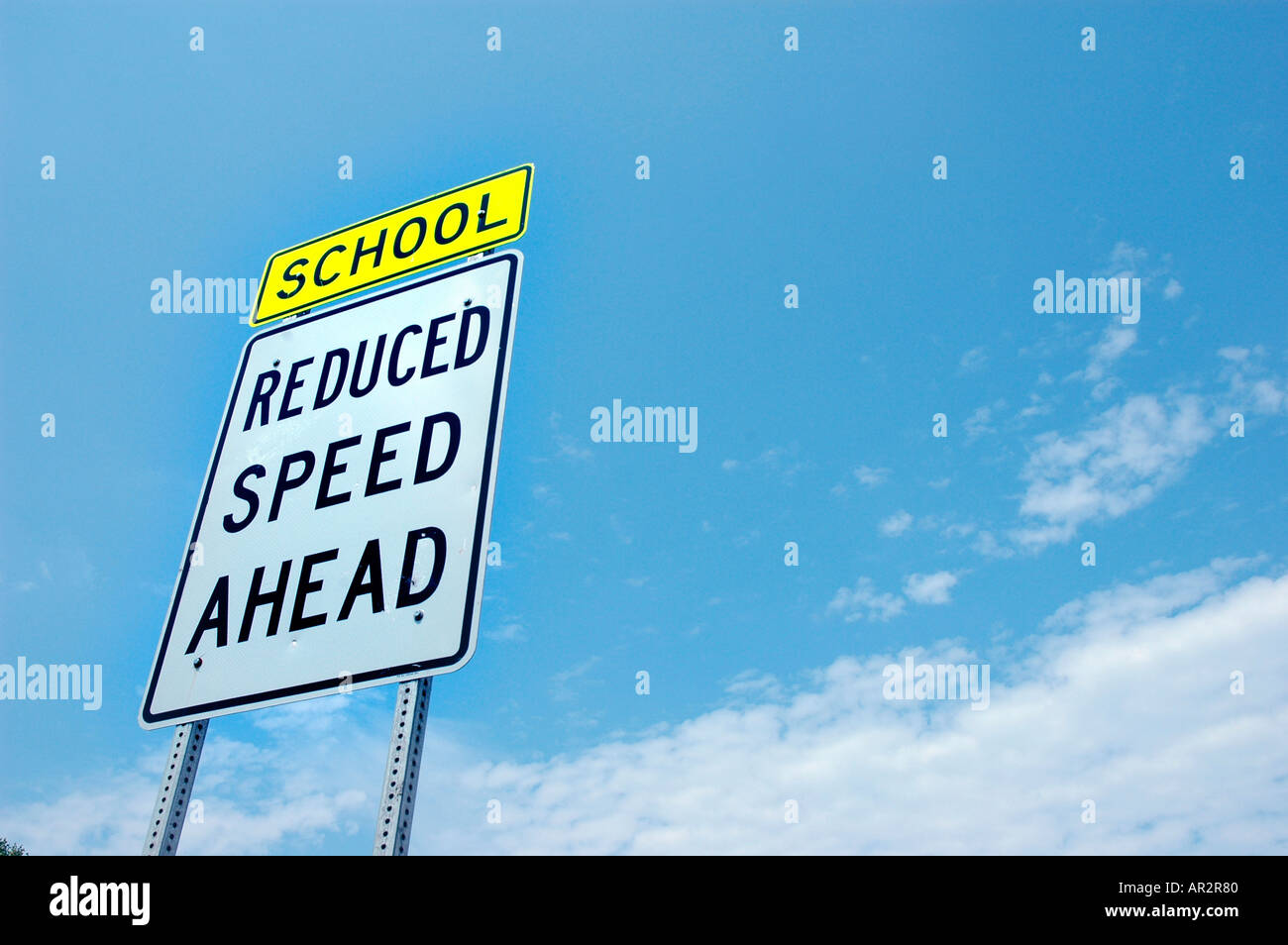 School Sign reduced speed ahead warning Stock Photo - Alamy