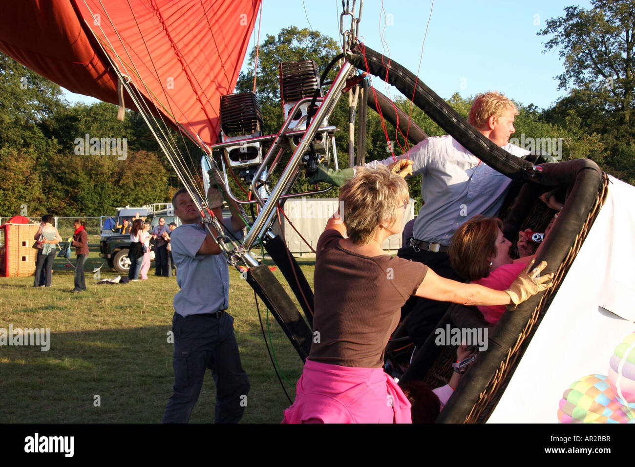 early morning sunshine a large passenger carrying balloon getting ready ...