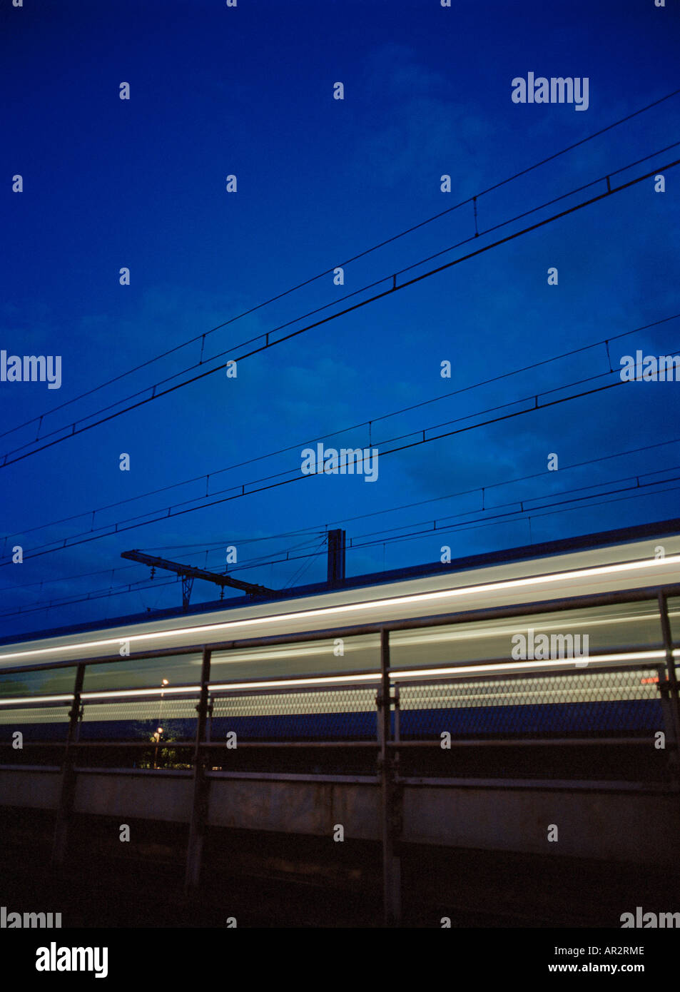 Train traveling across bright at night Stock Photo - Alamy