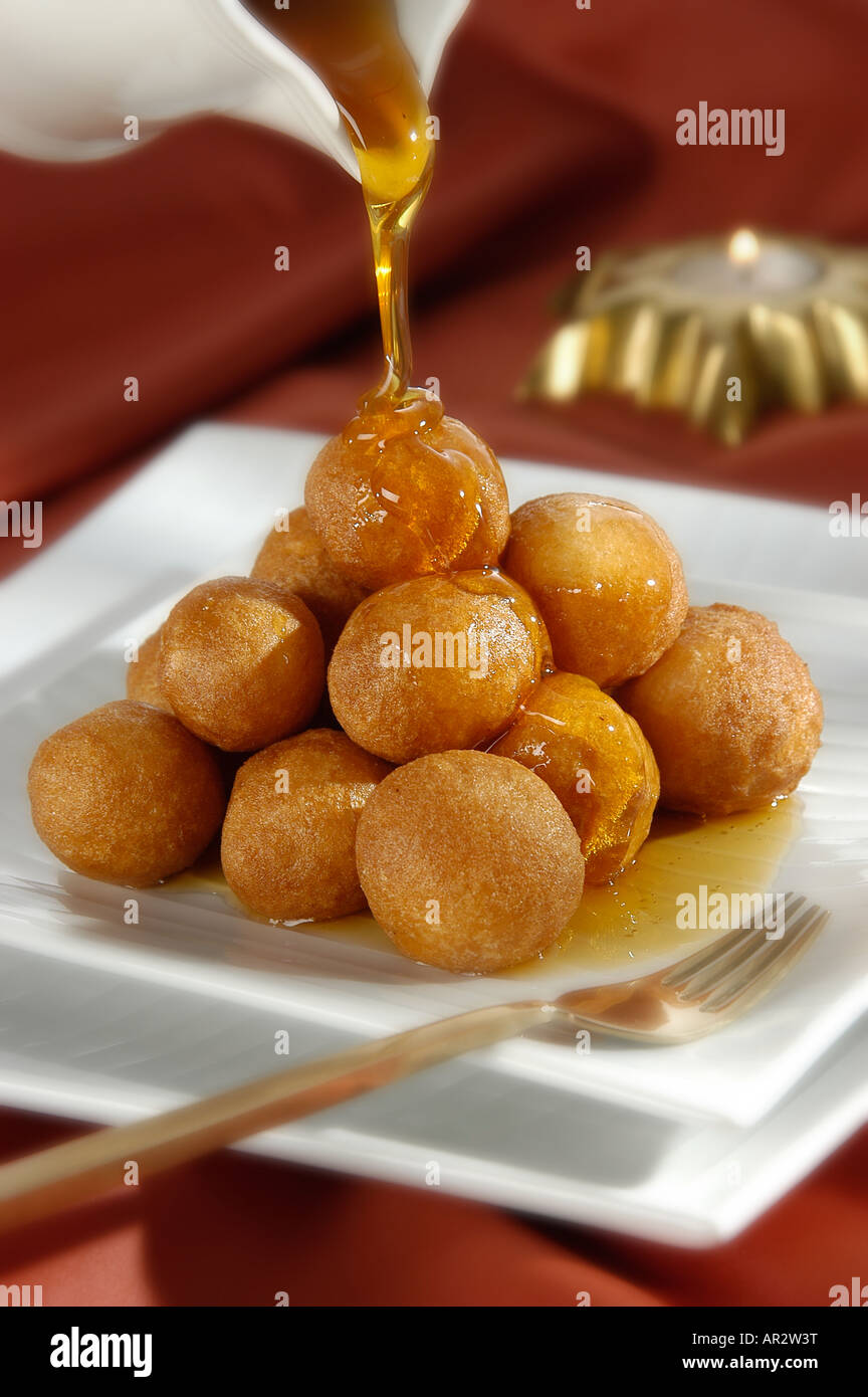 pyramid of mini doughnut balls with syrup Stock Photo - Alamy
