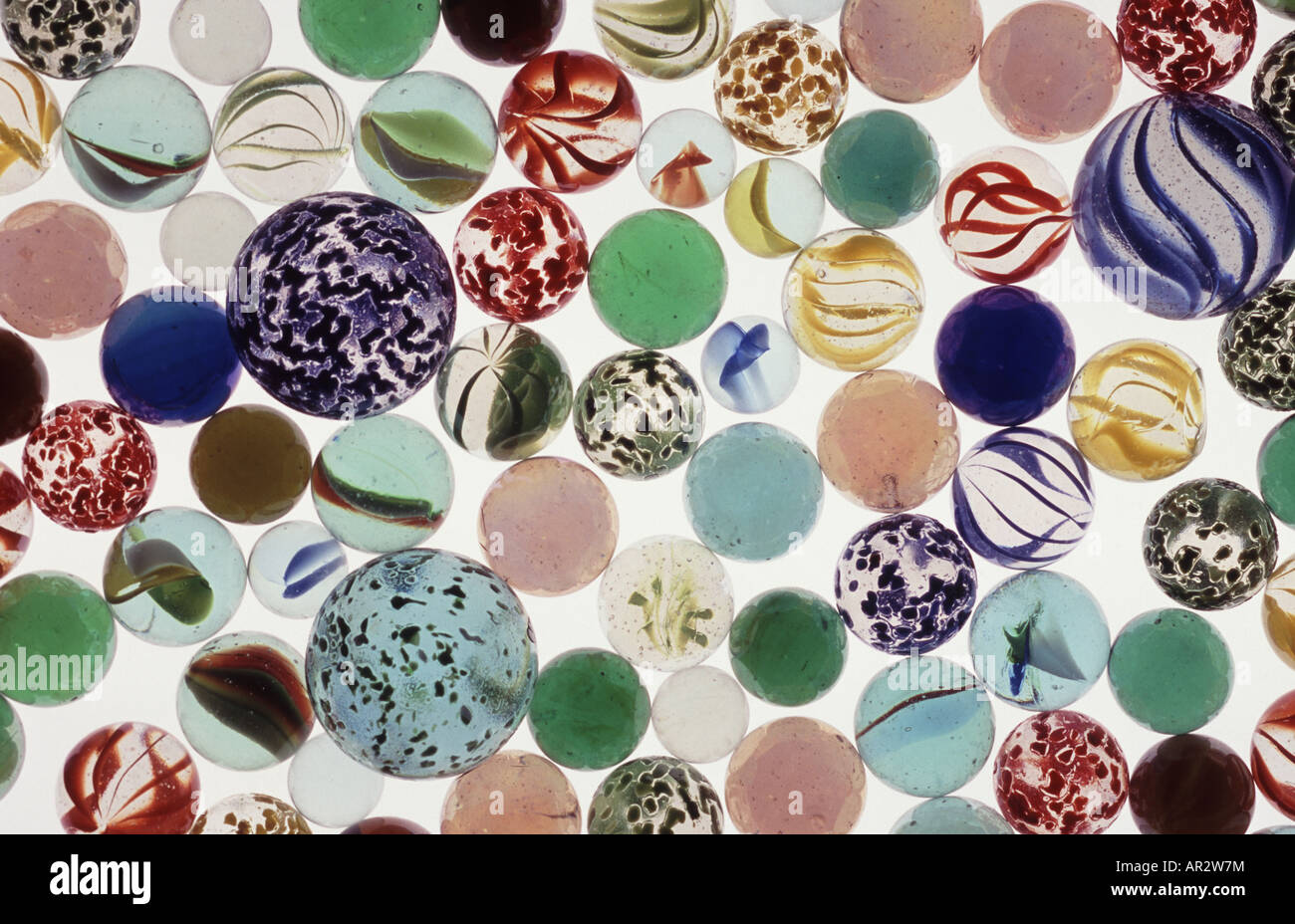 Colourful marbles backlit to show the variety of patterns and forms ...