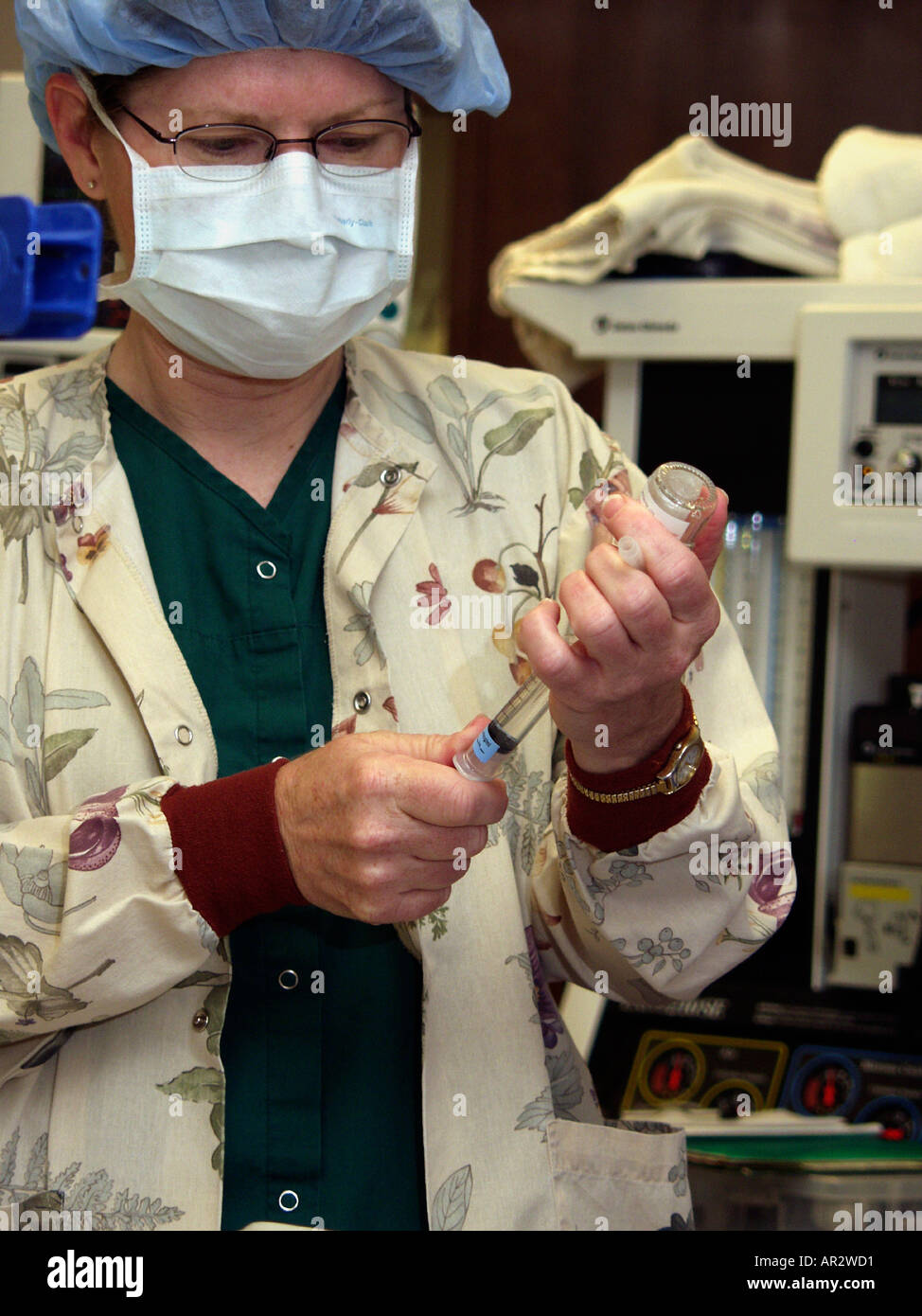 Doctor preparing to inject medication into I V during surgery Stock ...