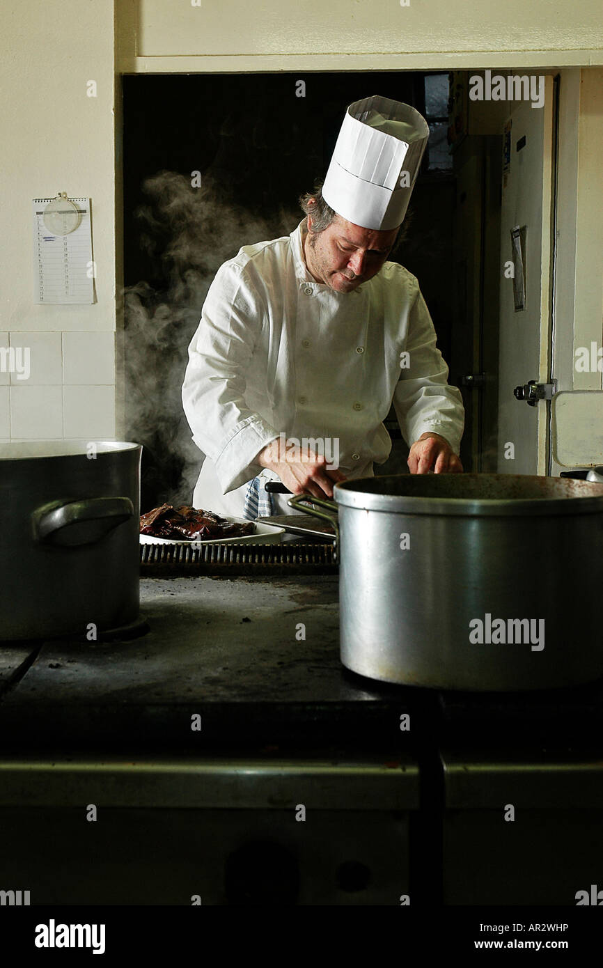 chef in a kitchen with steaming pots Stock Photo - Alamy
