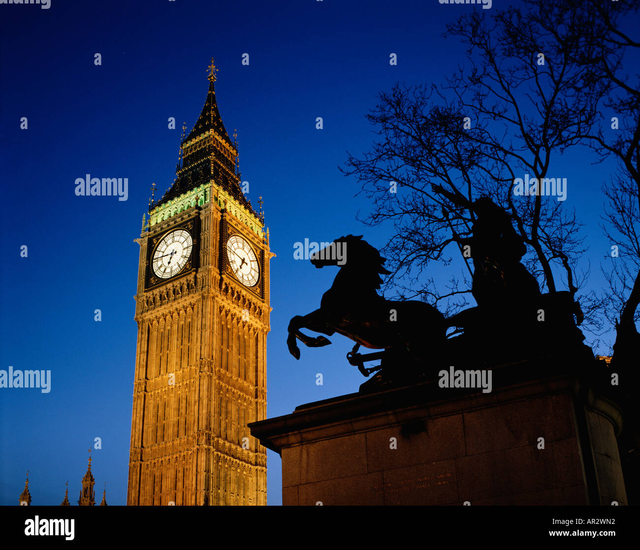 Big Ben clock floodlit at night, with the Statue of Boadicea ...