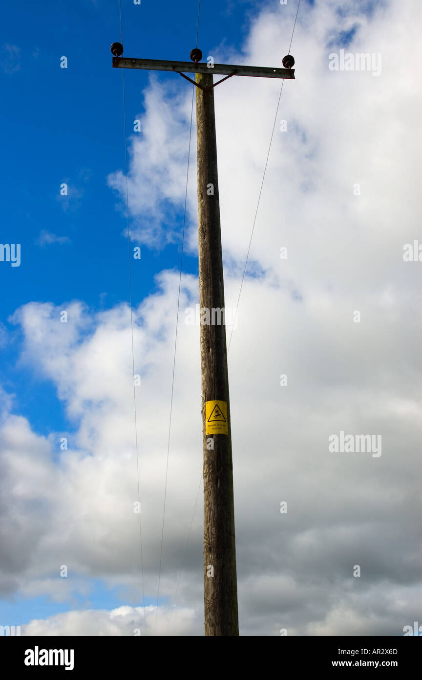 Overhead power cables with danger of death sign Stock Photo - Alamy