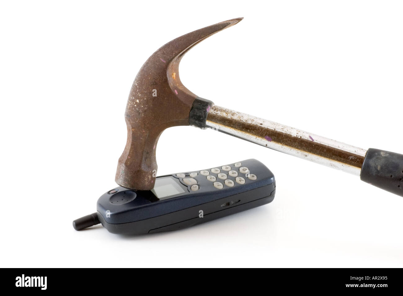 An old mobile phone being recycled with the help of a hammer Stock ...