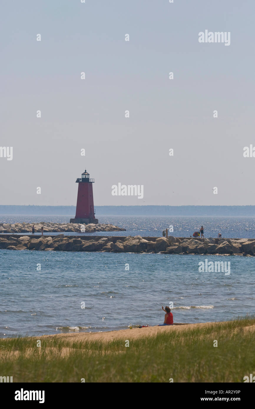 Lighthouse and tourists at the Lake Michigan beach at Manistique ...