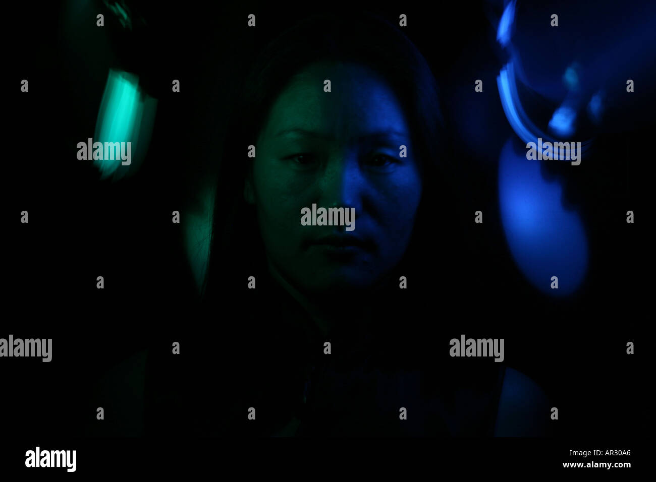 strange woman in blue and green light Stock Photo - Alamy