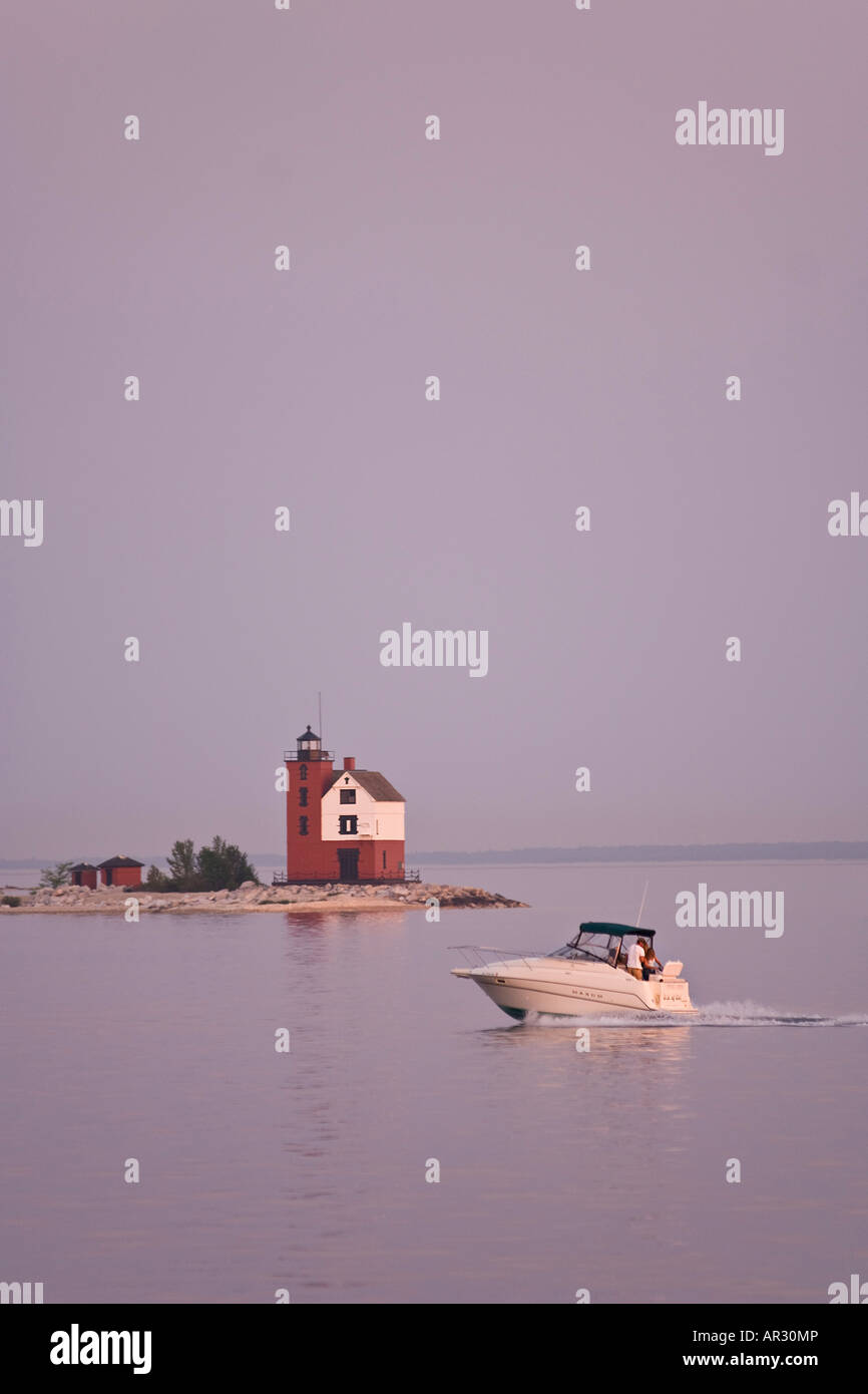 A boat passes the Round Island Lighthouse in Lake Huron at the Straits ...