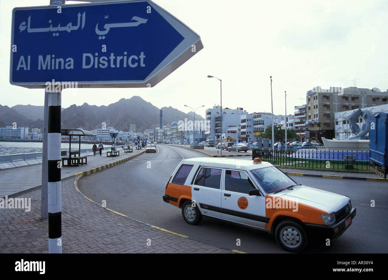 Street sign and taxi in front of the houses of Muscat, Oman, Middle ...